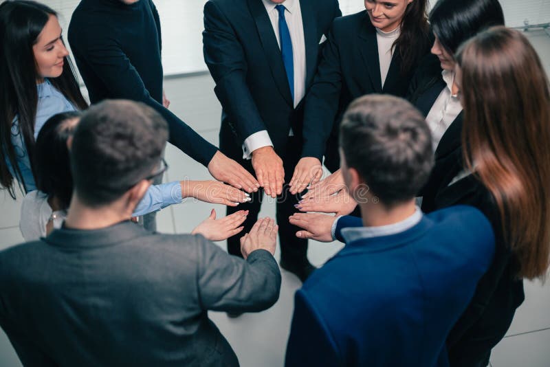Close Up. Group of Young Employees Standing in a Circle Stock Photo ...