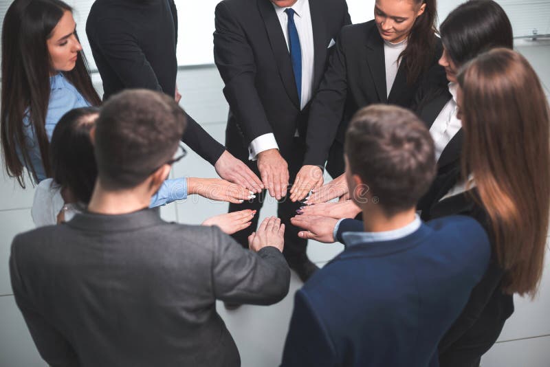 Close Up. Group of Young Employees Standing in a Circle Stock Photo ...