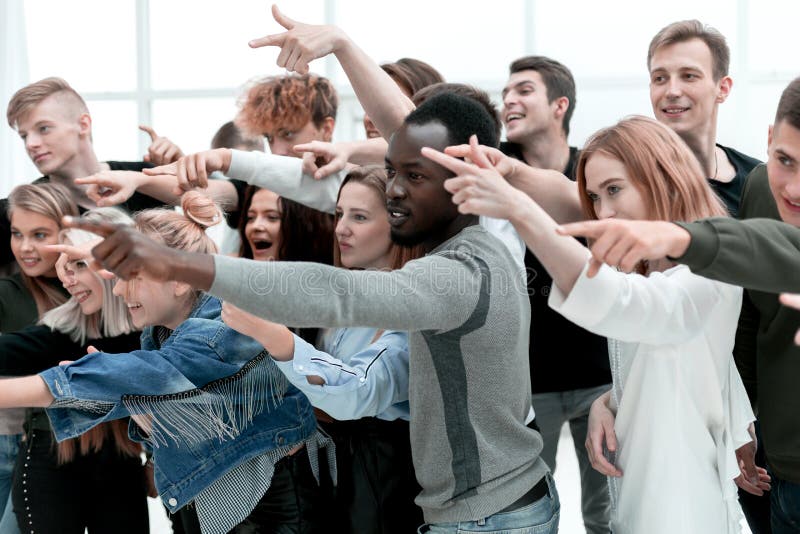 Close Up. a Group of Young People Pointing at One Point Stock Photo ...