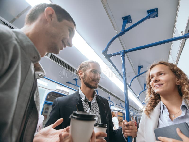 Group of Young People Talking while Standing on a Subway Train. Stock ...