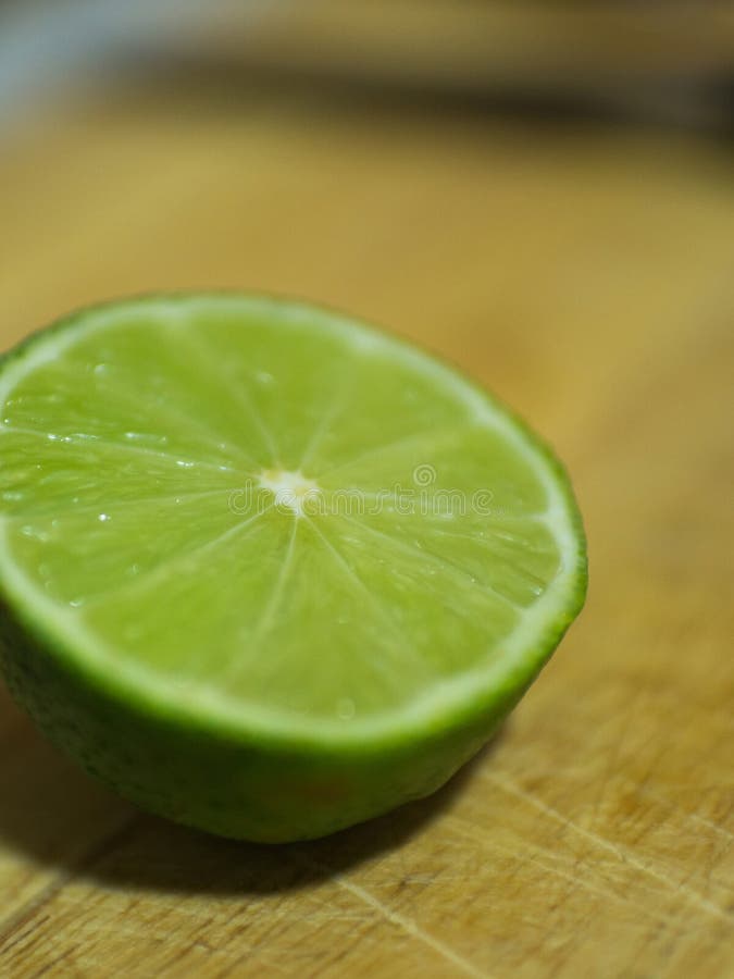 Close Up of Half Lime on a Wooden Cutting Table Stock Image - Image of ...