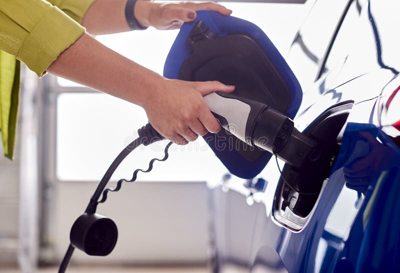 Close Up of Hand Attaching Charging Cable To Environmentally Friendly ...