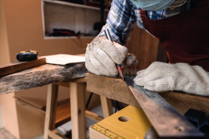 Close Up Hand of Carpenter Using Square Angle Ruler Tool and Pencil To ...