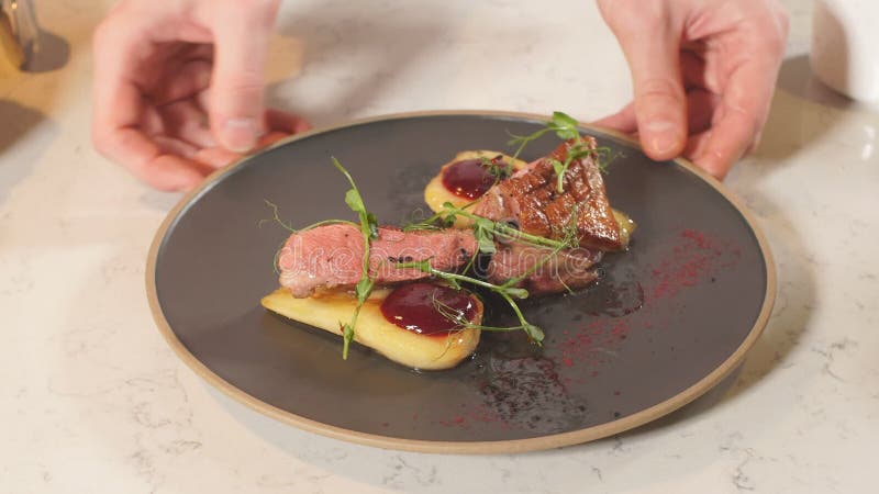 Close Up Hand of Chef Presents His Special Dish. he Stands in a Big ...