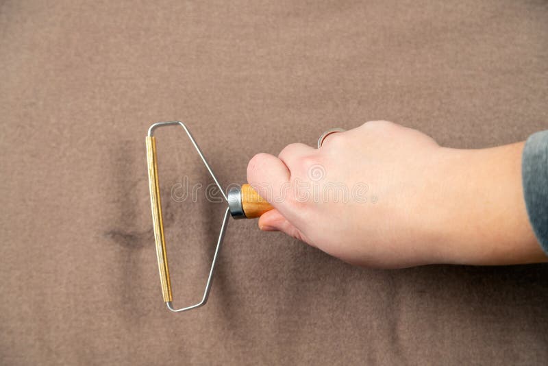Close Up of Hand Cleaning Sofa Surface with a Carpet Scraper Tool. Rug ...