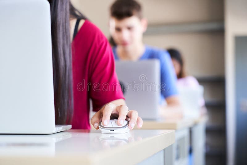 Close-up of a Hand Clutching a Mouse in a High School Classroom, a ...