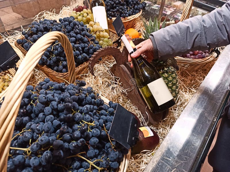 Close-up Hand of a Customer Choosing Wine, Standing by a Counter with ...
