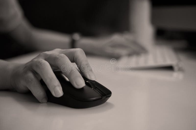 Hand Gripping Computer Mouse in Modern Office Setting Stock Photo ...