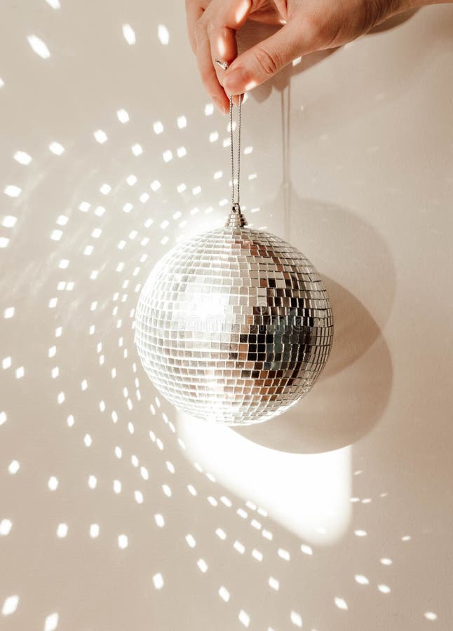 Close-up of a Hand Holding a Disco Ball, Casting Reflections and Light ...