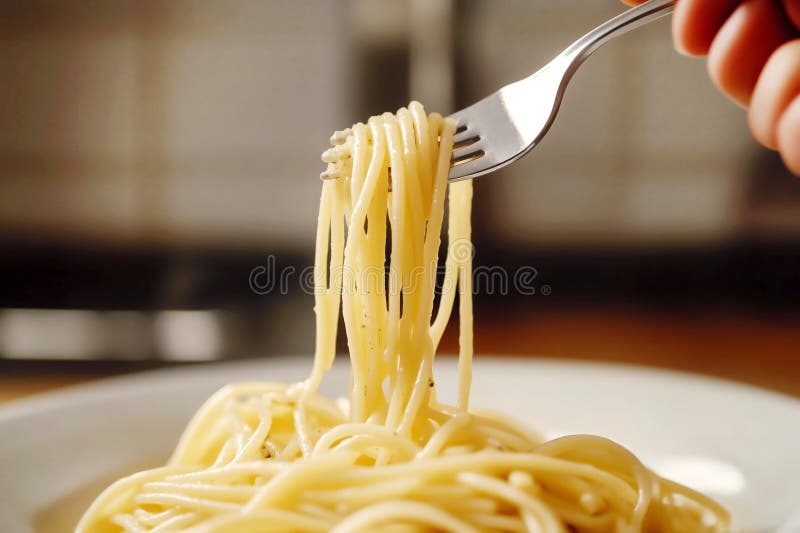 Close-up of a Hand Holding a Fork with Spaghetti Over a Plate in the ...