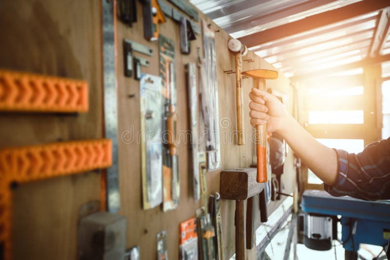 Close Up Hand Holding Hummer and Put and Keep in Store Tools Shop Stock ...