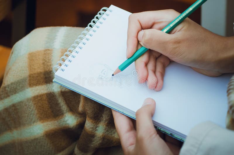 Close-up of Hand Holding Pencil and Drawing in Notebook Stock ...