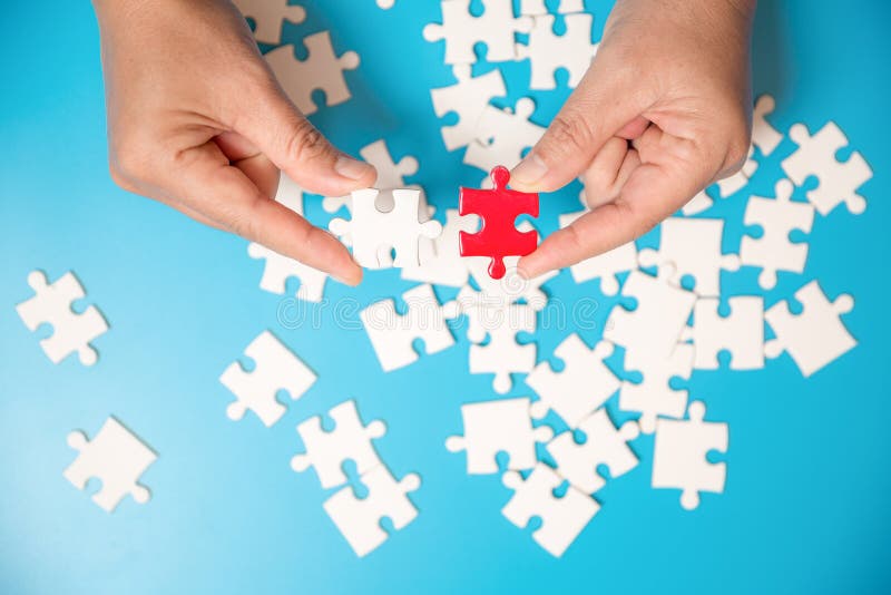 Close Up Hand Holding and Playing Jigsaw Game Incomplete. White Part of ...