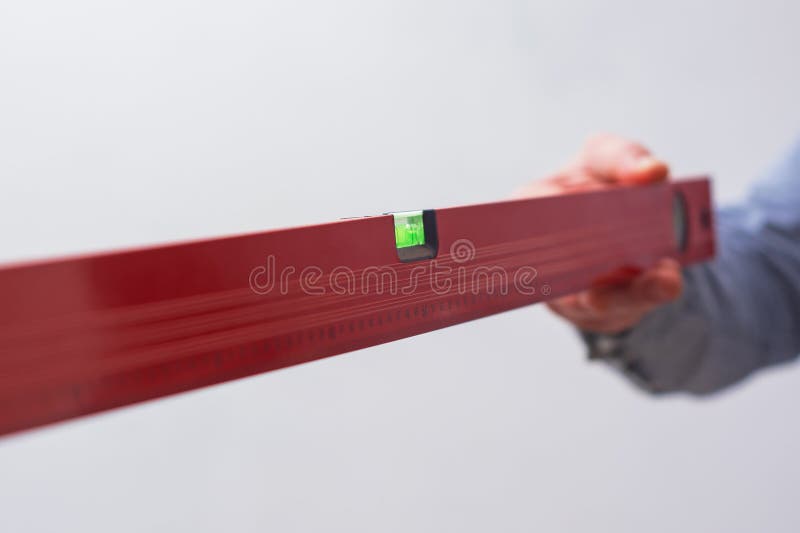 Close-up of a Hand Holding a Red Construction Level. Tool for DIY ...