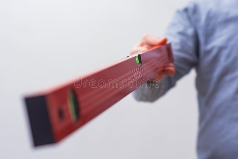 Close-up of a Hand Holding a Red Construction Level. Tool for DIY ...