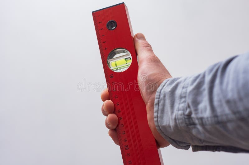 Close-up of a Hand Holding a Red Construction Level. Tool for DIY ...