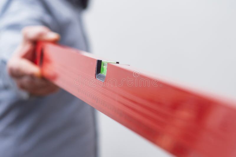Close-up of a Hand Holding a Red Construction Level. Tool for DIY ...