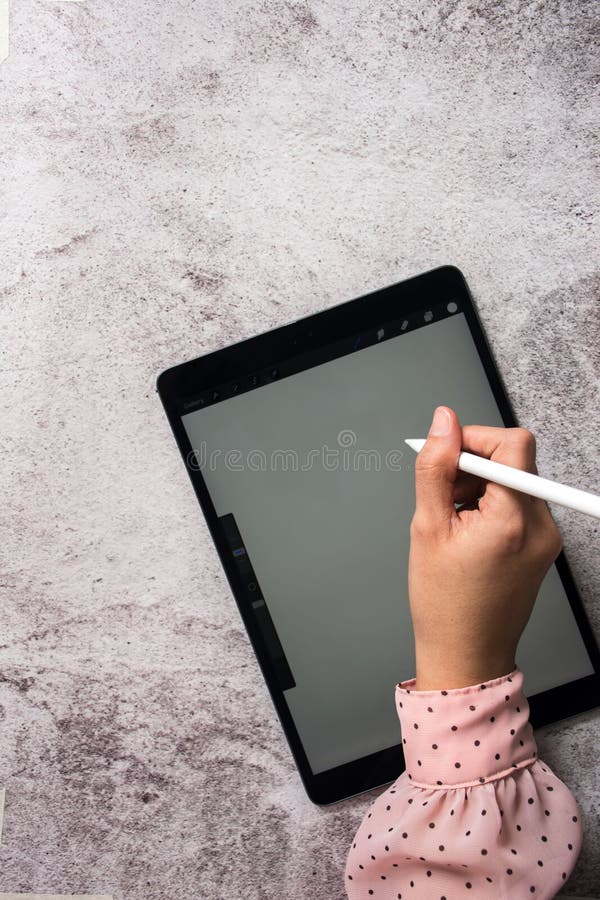 Close-up of a Hand Holding a Stylus on a Digital Tablet with a Textured ...