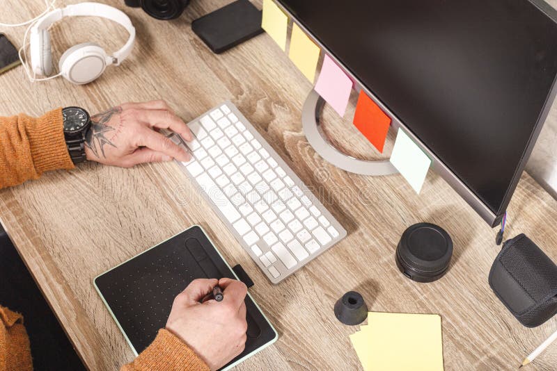 Close Up of Hand Holding Stylus on Graphics Tablet for Retouching Work ...