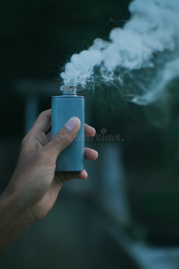 Close-Up Hand is Holding a Vape that is Emitting Smoke Stock Image ...