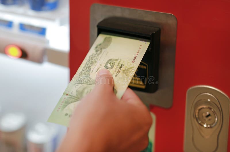 Close Up Hand Inserting Banknote into the Machine for Buying Food or ...