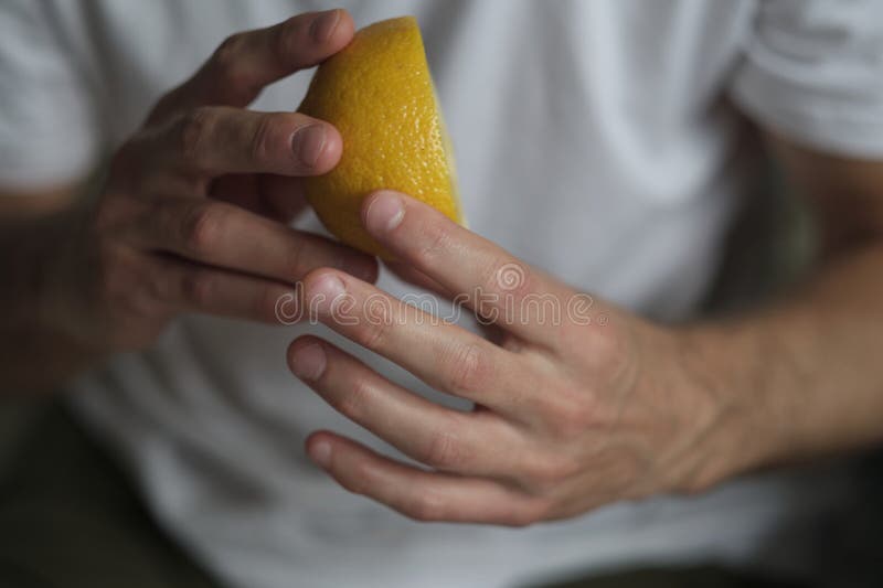 Close-up of a Hand with a Lemon Slice, Emphasizing the Fruits Texture ...