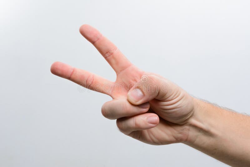 Hand Gesturing the Number Two Against a Plain Background. Stock Photo ...