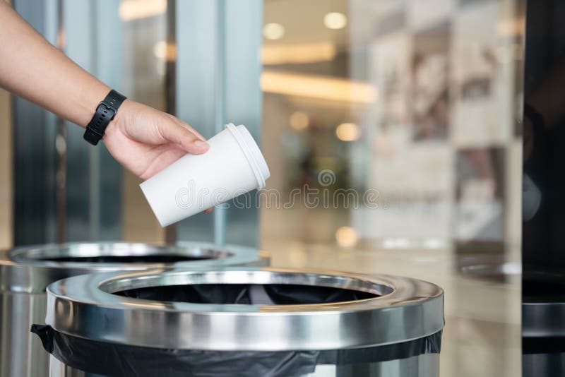 Close-up Hand of a Man Throwing Empty Paper Coffee Cup in Recycling Bin ...