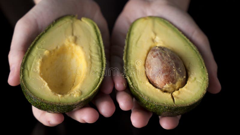 Close Up Hand Open Avocado Fruit Stock Photo - Image of green, cookery ...