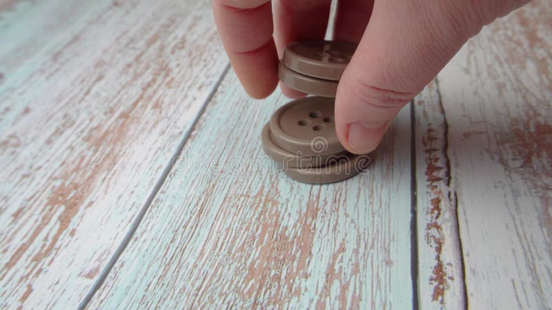 A Stack of Buttons on a Wooden Surface Stock Video - Video of buttons ...