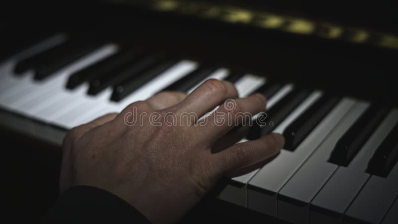 Close-up of Hand Playing Piano. Media. Light Falling on Hand Playing ...