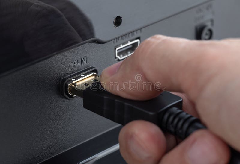 Close-up of a Hand Plugging a DisplayPort Cable into the Connector DP ...