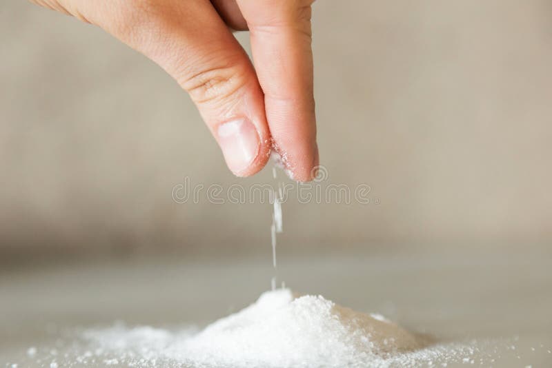 A Close-up of a Hand Pours a Hill of Salt. Microplastic Problem in Salt ...