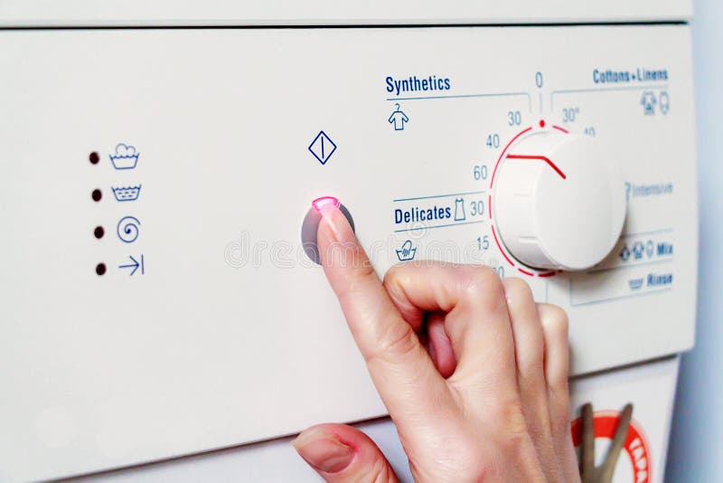 Close Up Hand Presses Start on Washing Machine Stock Photo - Image of ...