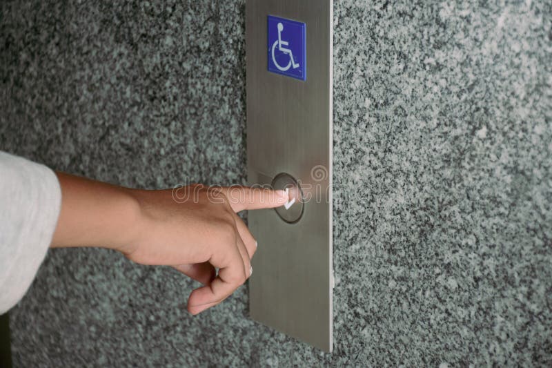 Close-up Hand Pressing the Button for the Disabled Elevator To Go Down ...