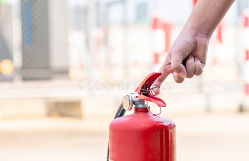 Close Up of a Hand Pulling the Safety Pin of a Fire Extinguisher Stock ...