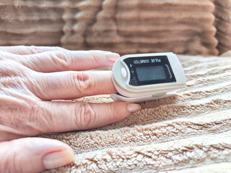 Close Up of a Hand with a Pulse Oximeter on the Finger. Stock Image ...