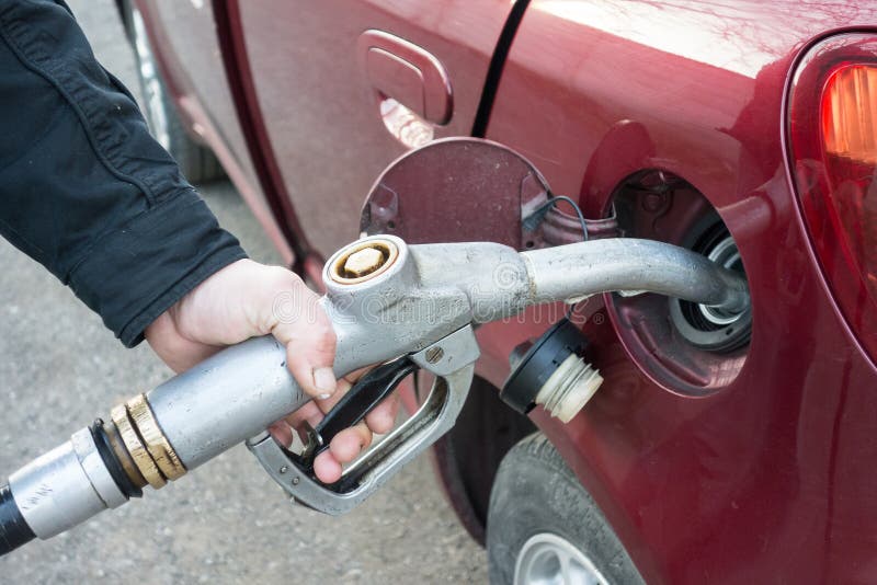 Close-up of a Hand Pumping Gas in the Car with a Gas Pump Stock Photo ...