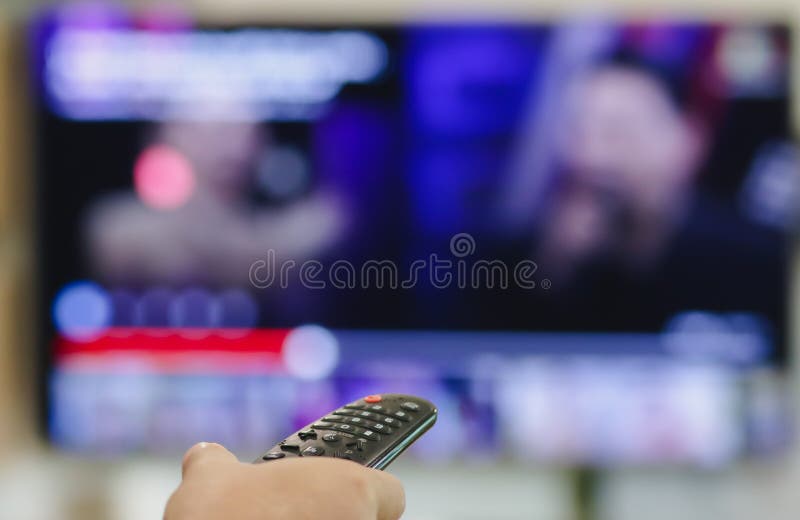 Close-up of Hand with the Remote Control Television and Presses the ...