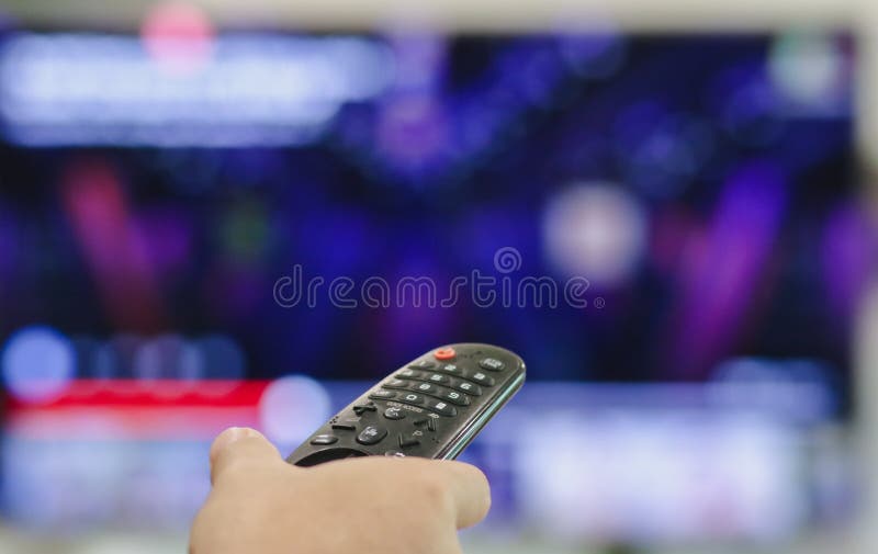 Close-up of Hand with the Remote Control Television and Presses the ...