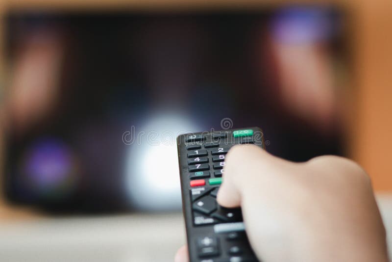 Close-up of Hand with the Remote Control Television and Presses the ...