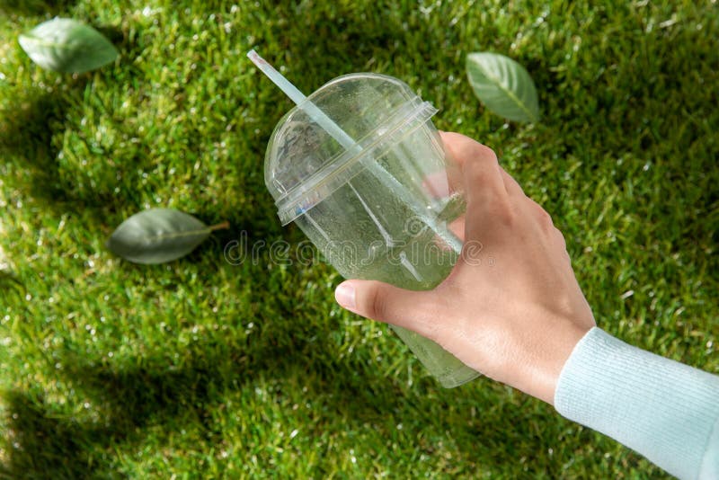 Close Up of Hand Removing Plastic Cup from Grass Stock Image - Image of ...