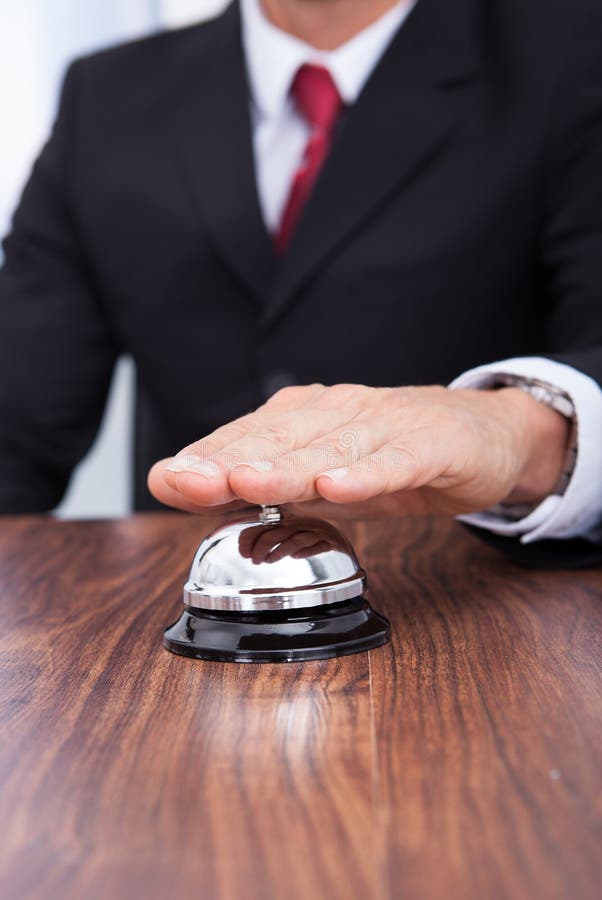 Businessman Ringing in Service Bell Held by Bellboy Stock Photo - Image ...