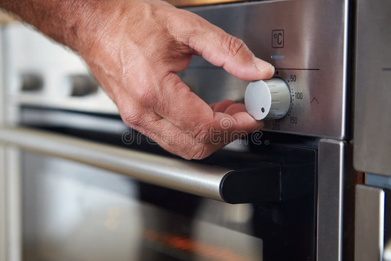 Close Up of Hand Setting Temperature Control on Oven Stock Image ...