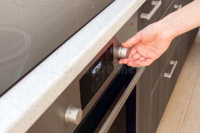 Close Up of Hand Setting Temperature Control on Oven. Stock Photo ...
