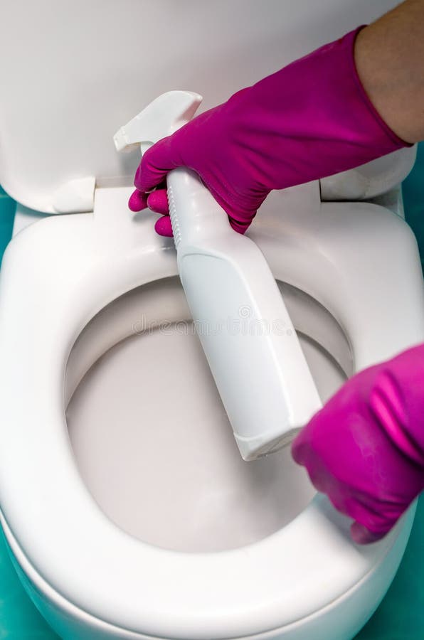 Close-up of a Hand Spraying Detergent on the Toilet. Toilet Cleaning ...