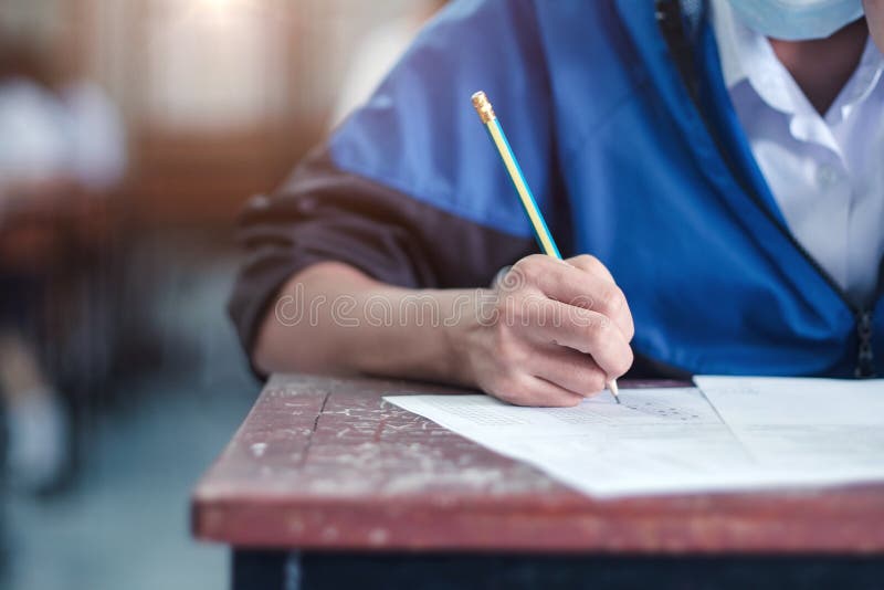 Close Up Hand of Student Reading and Taking Exam Sheets Exercises ...