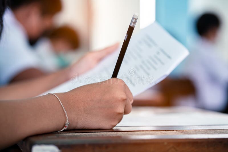 Close Up Hand of Students Reading and Taking Exam Sheets Exercises ...