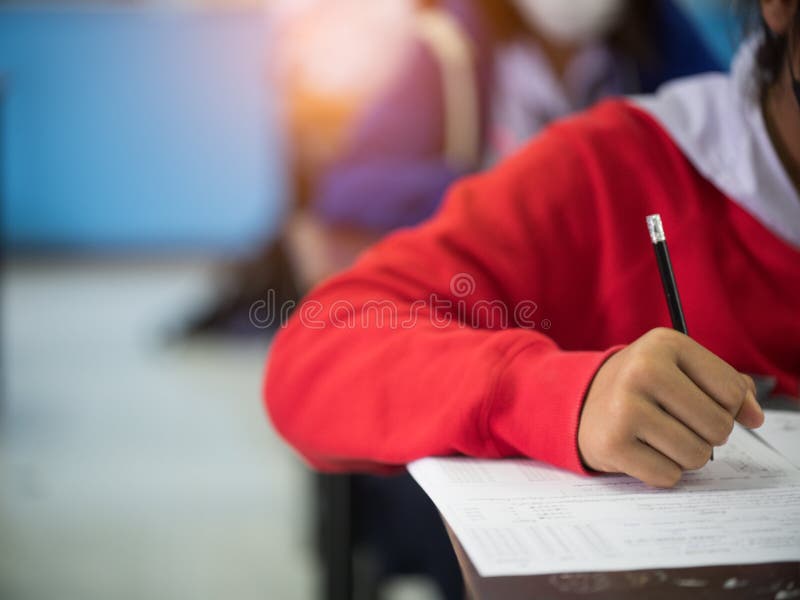 Close Up Hand of Students Reading and Taking Exam Sheets Exercises ...