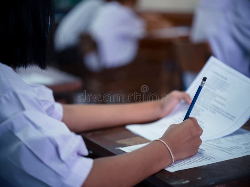 Close Up Hand of Students Reading and Taking Exam Sheets Exercises ...